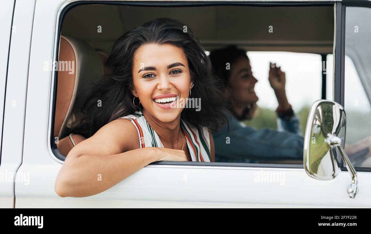 Attractive brunette woman looking outside the car window Stock Photo ...