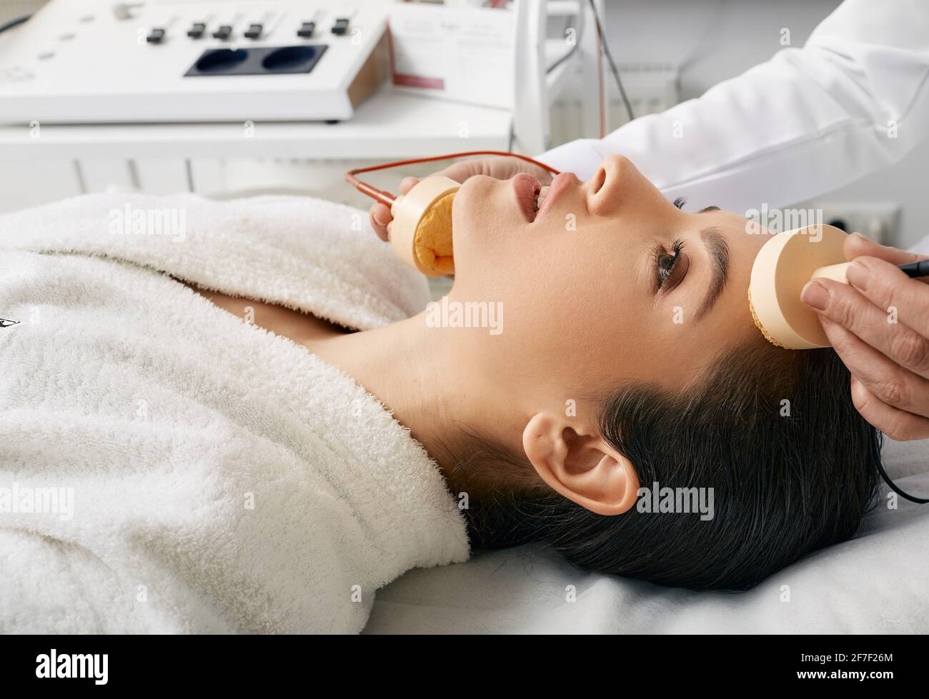 facial microcurrent procedure. Beautiful woman during facial ...