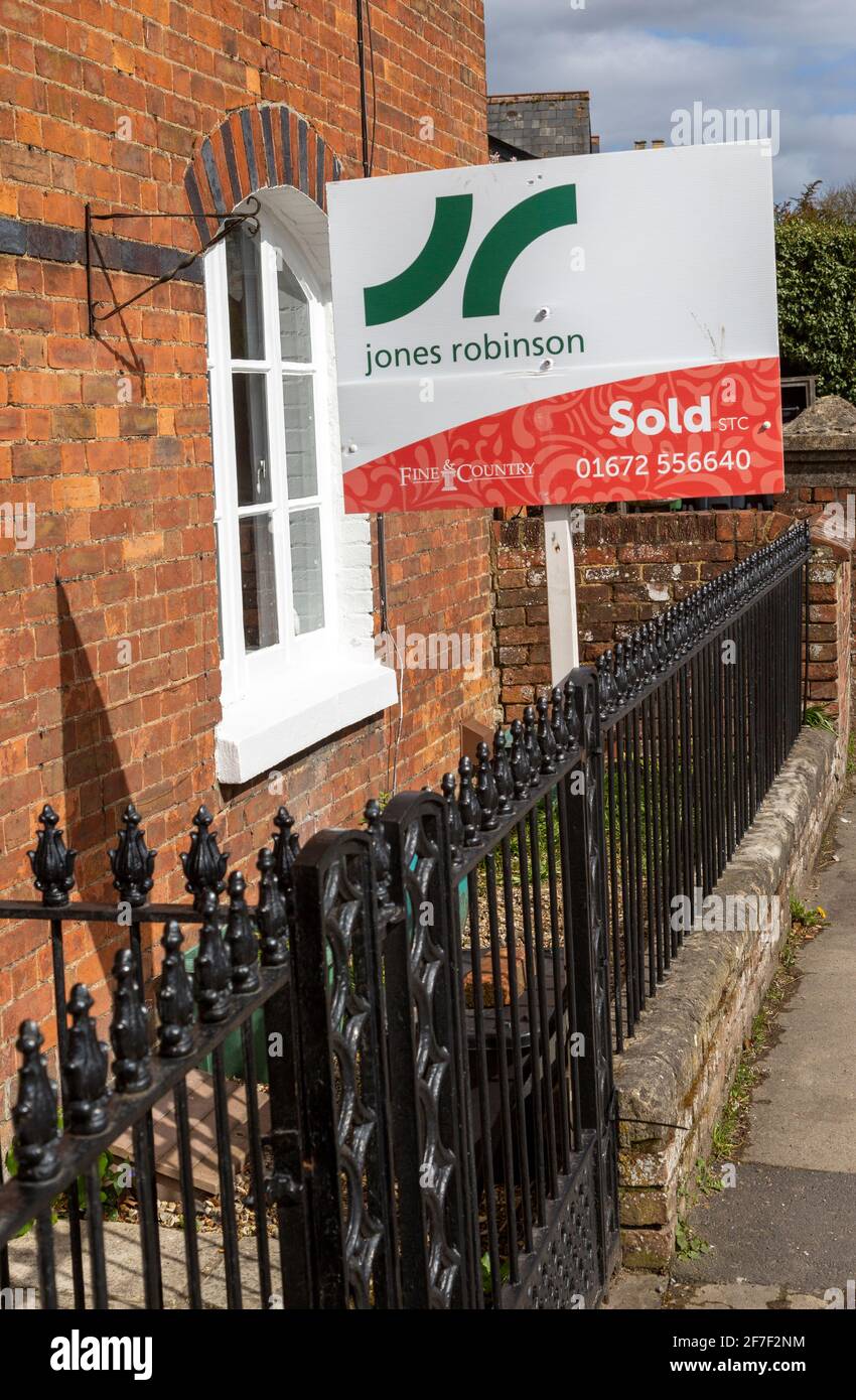 Estate agent property sold sign outside red brick historic house ...