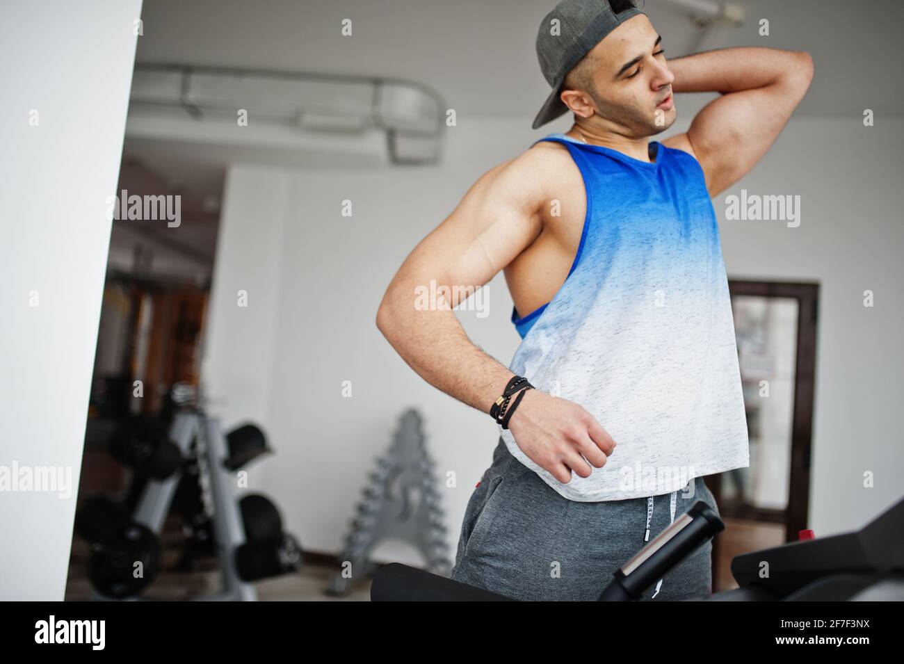 Fit and muscular arabian man running on treadmill in gym Stock Photo ...