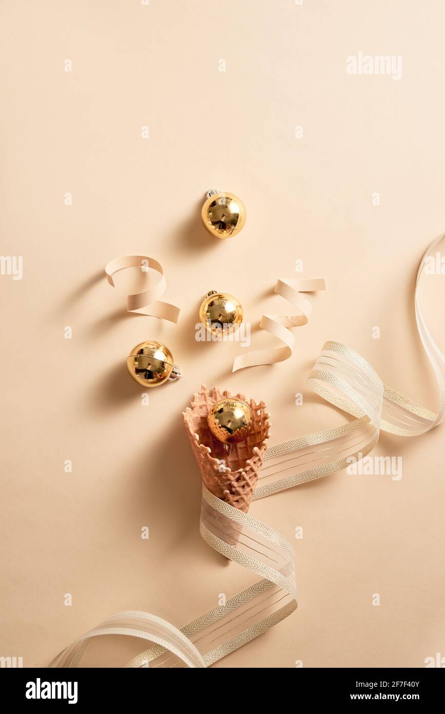 Ice cream waffle cone with ribbon and balls ornament topping. Skin ...