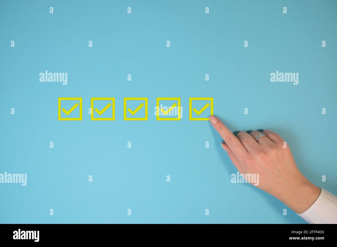 Yellow marking on checklist box isolated on blue background with copy ...