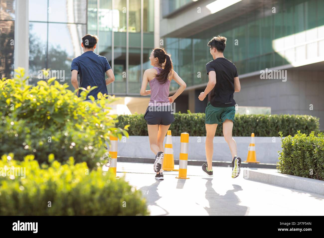 Young friends running outdoors Stock Photo - Alamy