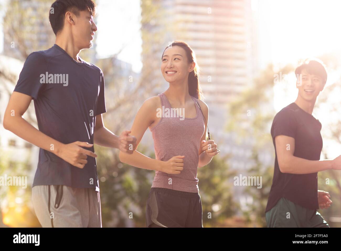 Young friends running outdoors Stock Photo - Alamy