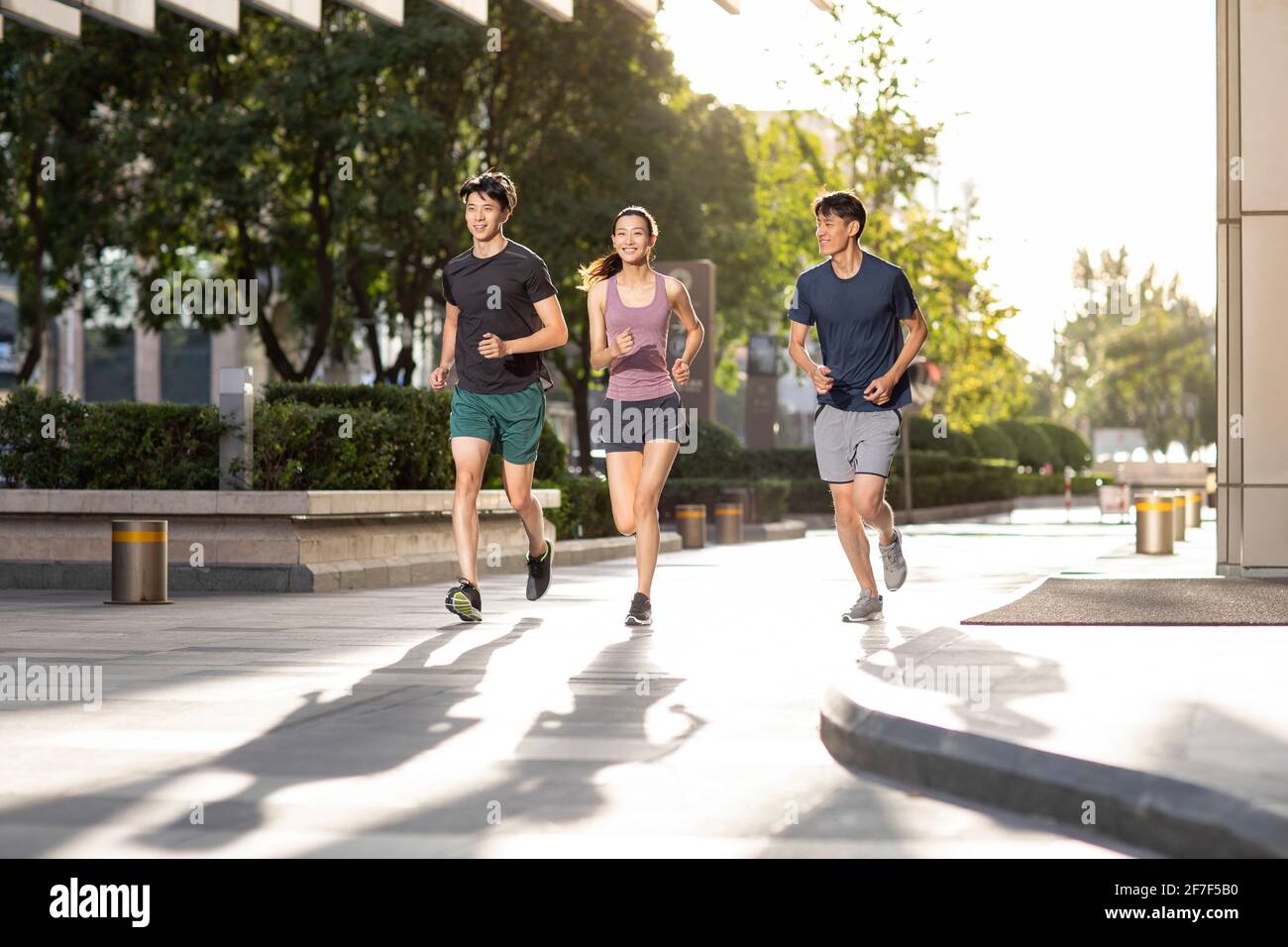 Young friends running outdoors Stock Photo - Alamy