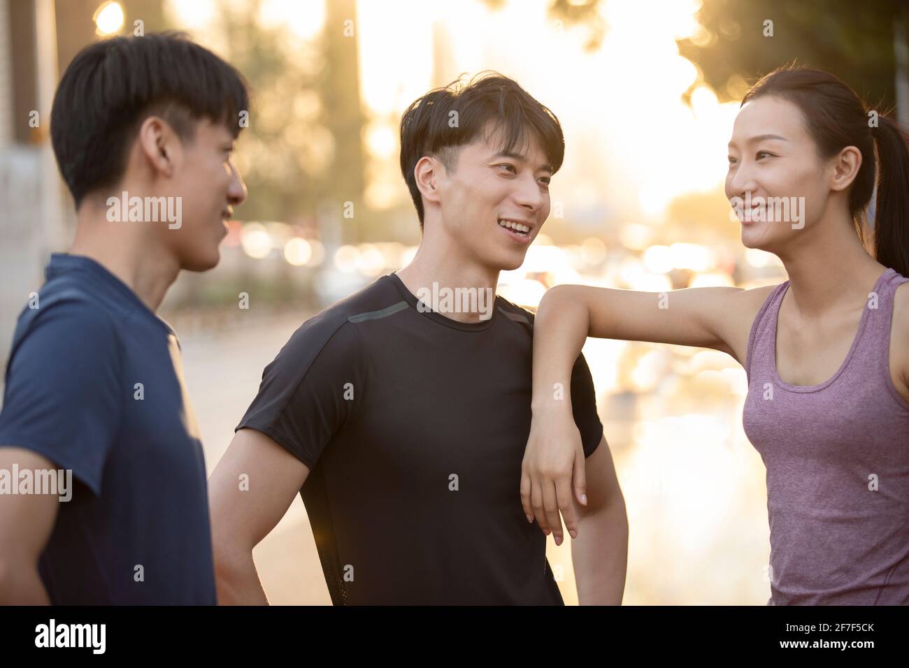 Young friends resting after exercising Stock Photo - Alamy