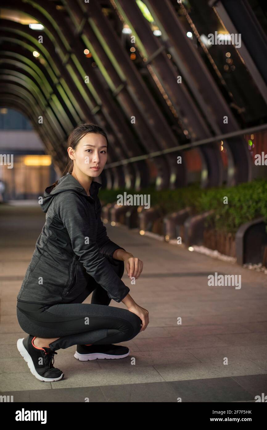 Young woman running at night Stock Photo - Alamy