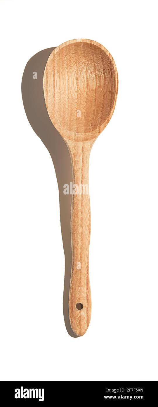 Wooden textured spoon isolated on a white background. With a shadow ...