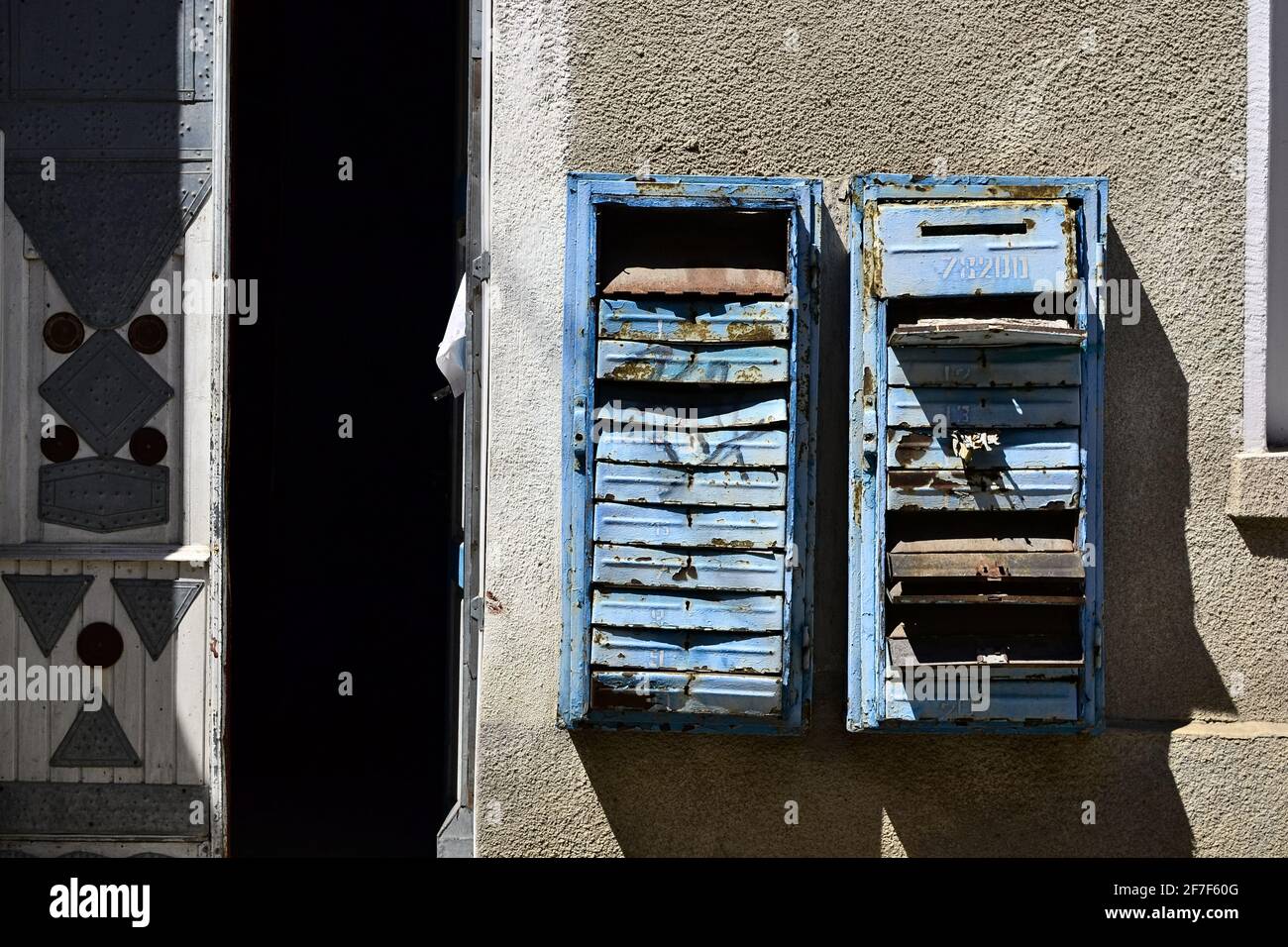 Old rusty mail boxes on the wall. Obsolete broken mailboxes Stock Photo ...