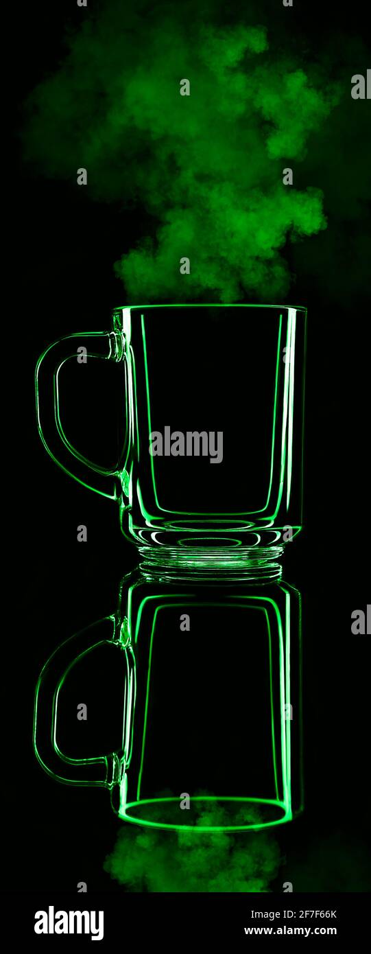 Just a glass on a black background with a reflection. Green color, with ...