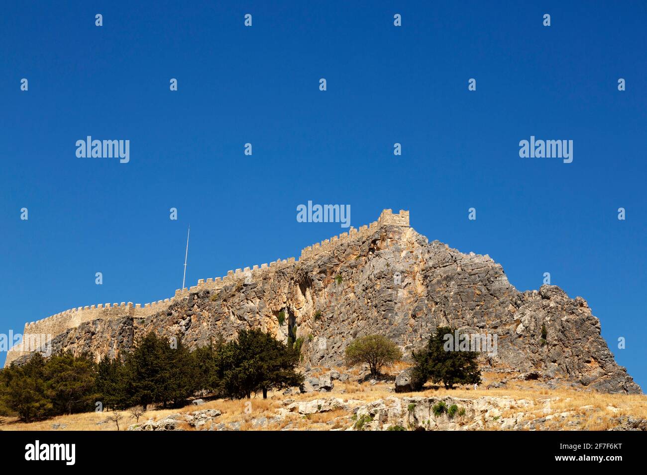 The crenelated wall of the citadel on the Lindian Acropolis in Lindos ...