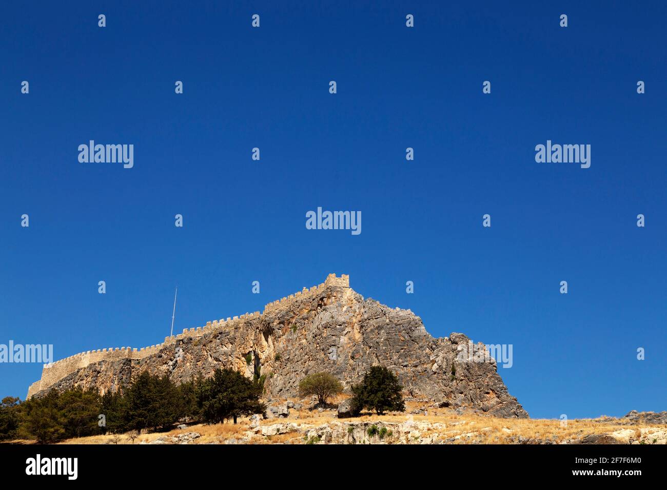 The crenelated wall of the citadel on the Lindian Acropolis in Lindos ...