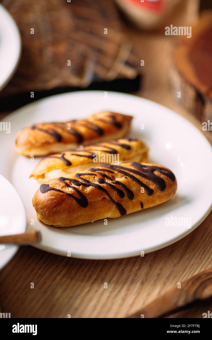 Plate chocolate eclairs hi-res stock photography and images - Alamy