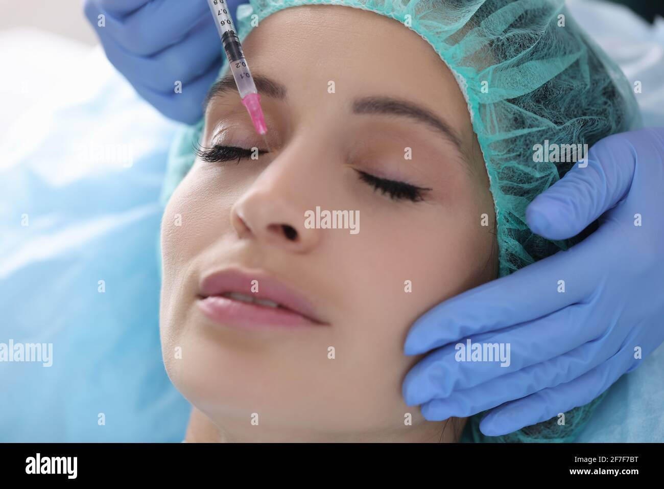 Beautician gives woman rejuvenating injection into skin of face Stock ...