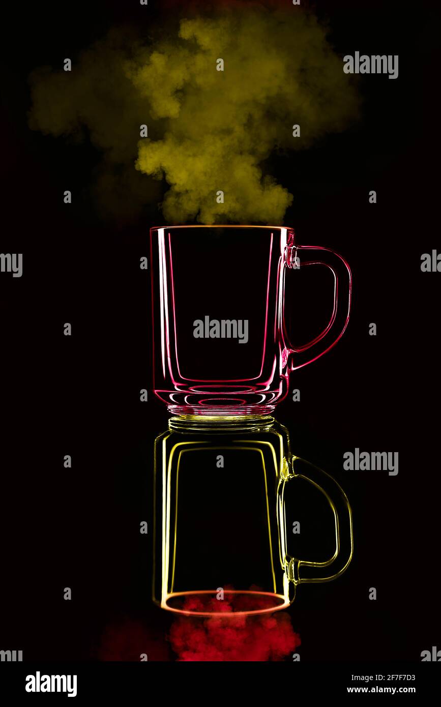 Just a glass on a black background with a reflection. Yellow and red ...