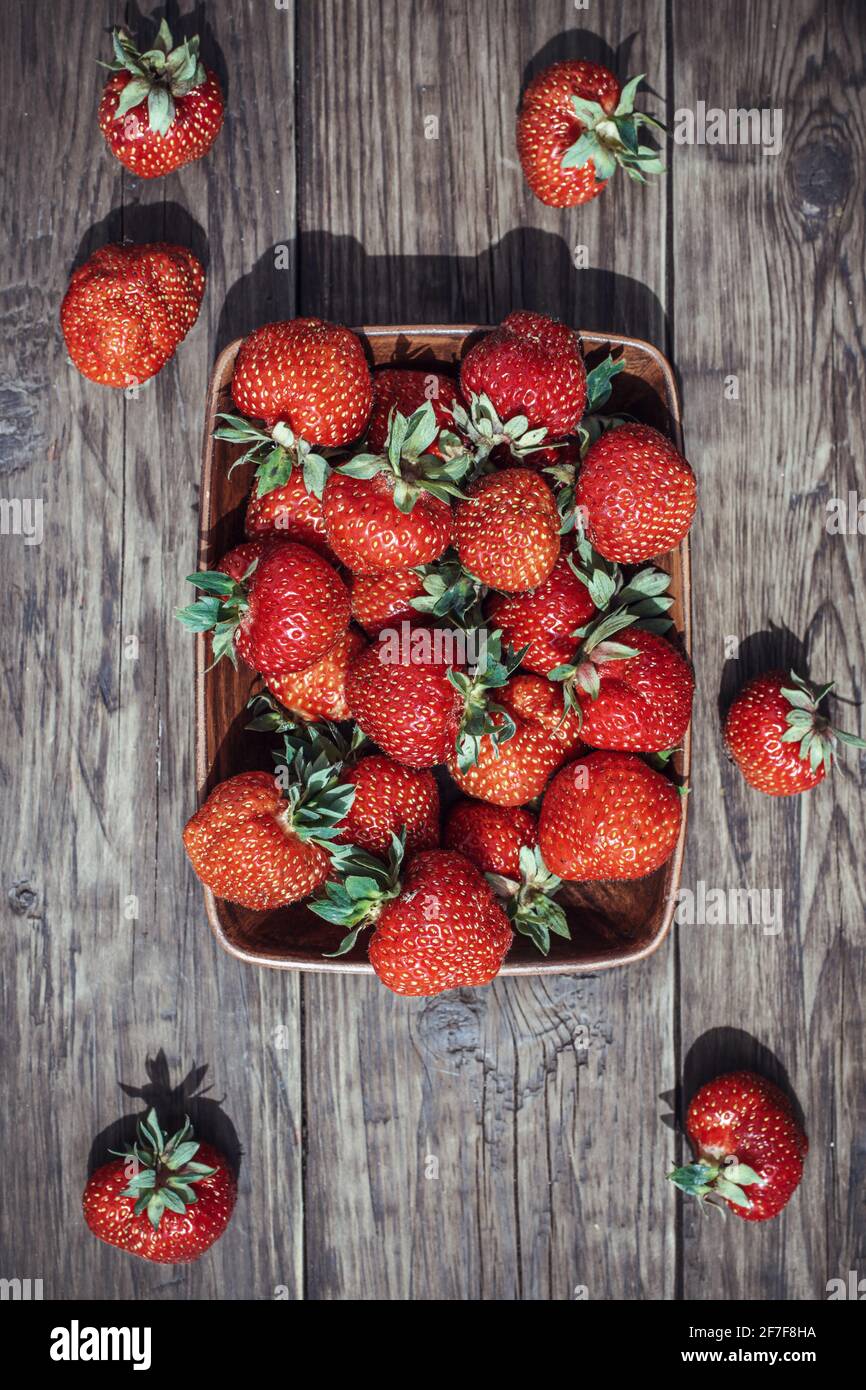 Strawberry in tray on old wooden table, top view. Hard light Stock ...