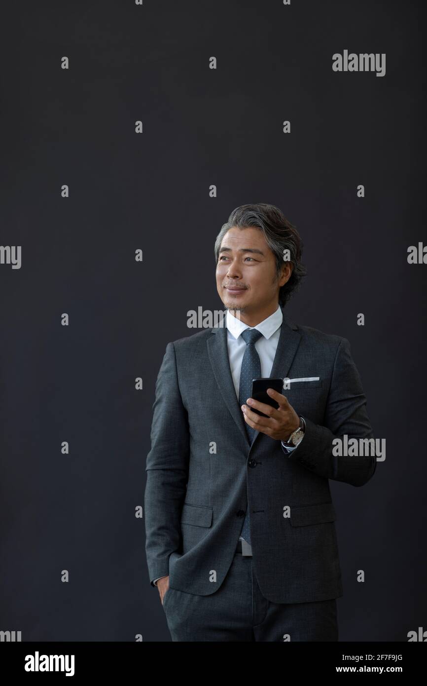 Successful businessman using smartphone Stock Photo - Alamy