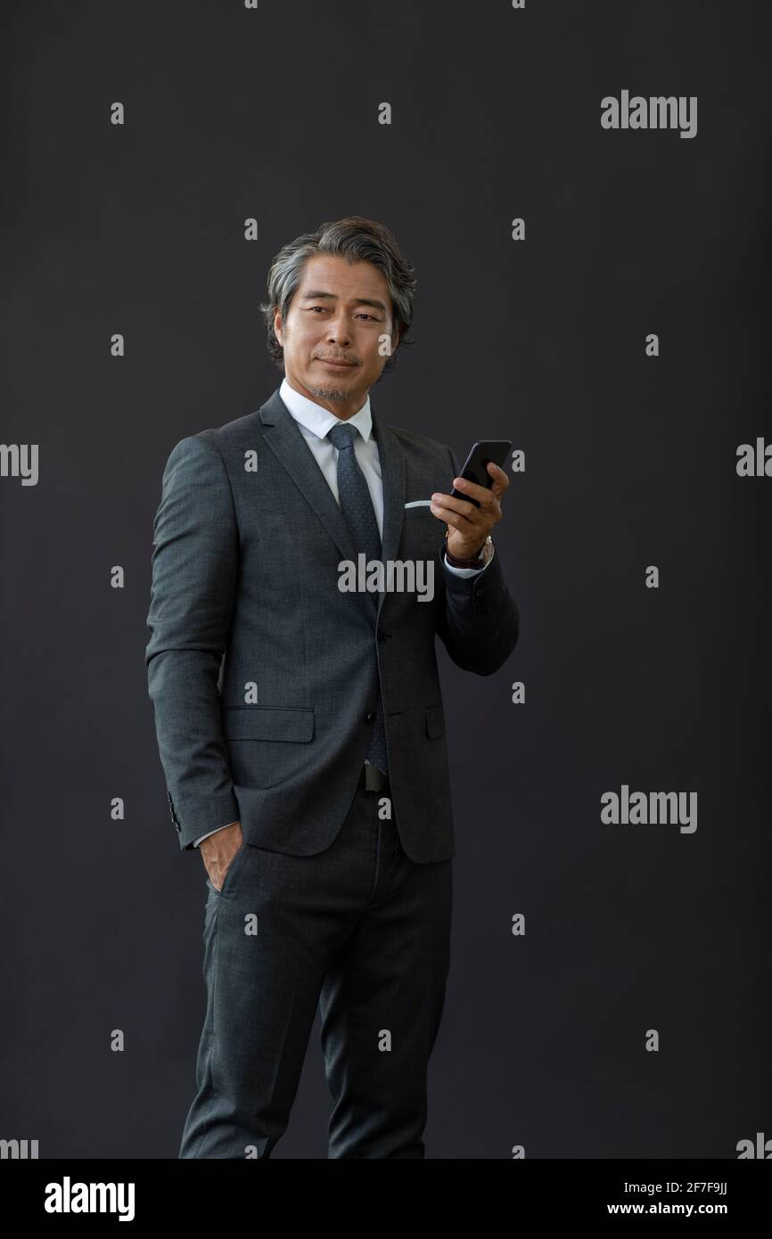 Successful businessman using smartphone Stock Photo - Alamy