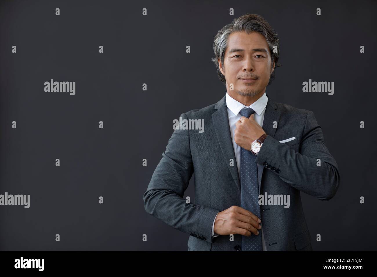 Businessman adjusting watch hi-res stock photography and images - Alamy