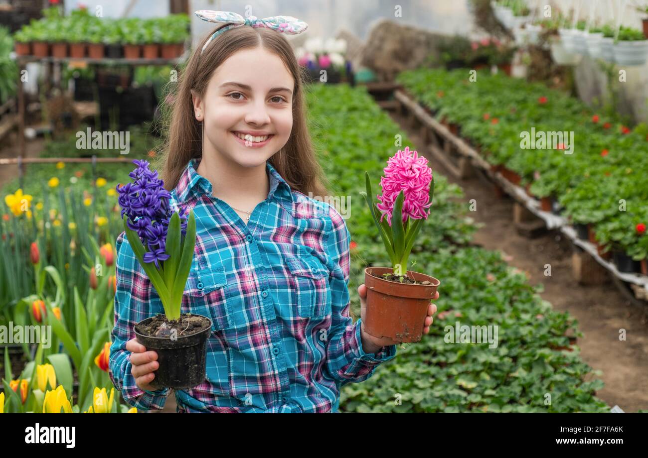 happy teen girl florist care pot plants in greenhouse, horticulture ...