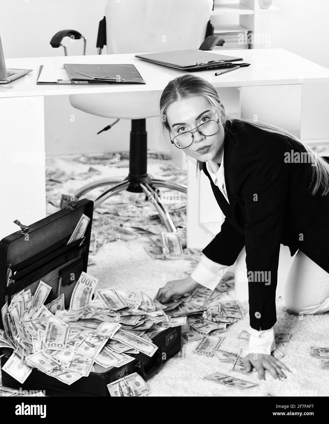 Woman counting money. Business investment. Office is littered with ...
