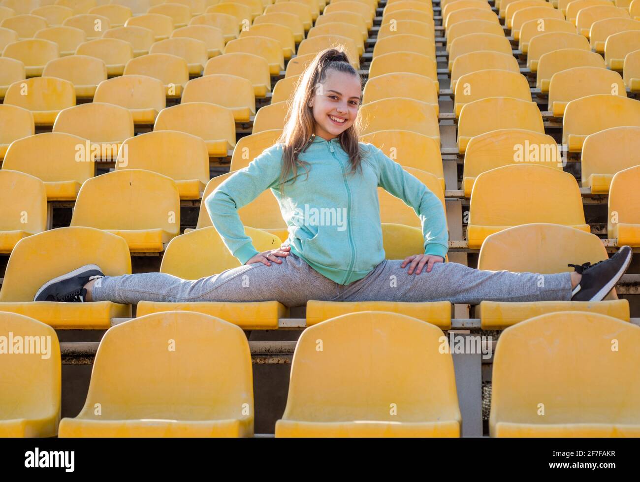 Stretch And Flex For Your Health Flexible Tween Do Splits On Stadium Seats Leg Stretch Stock