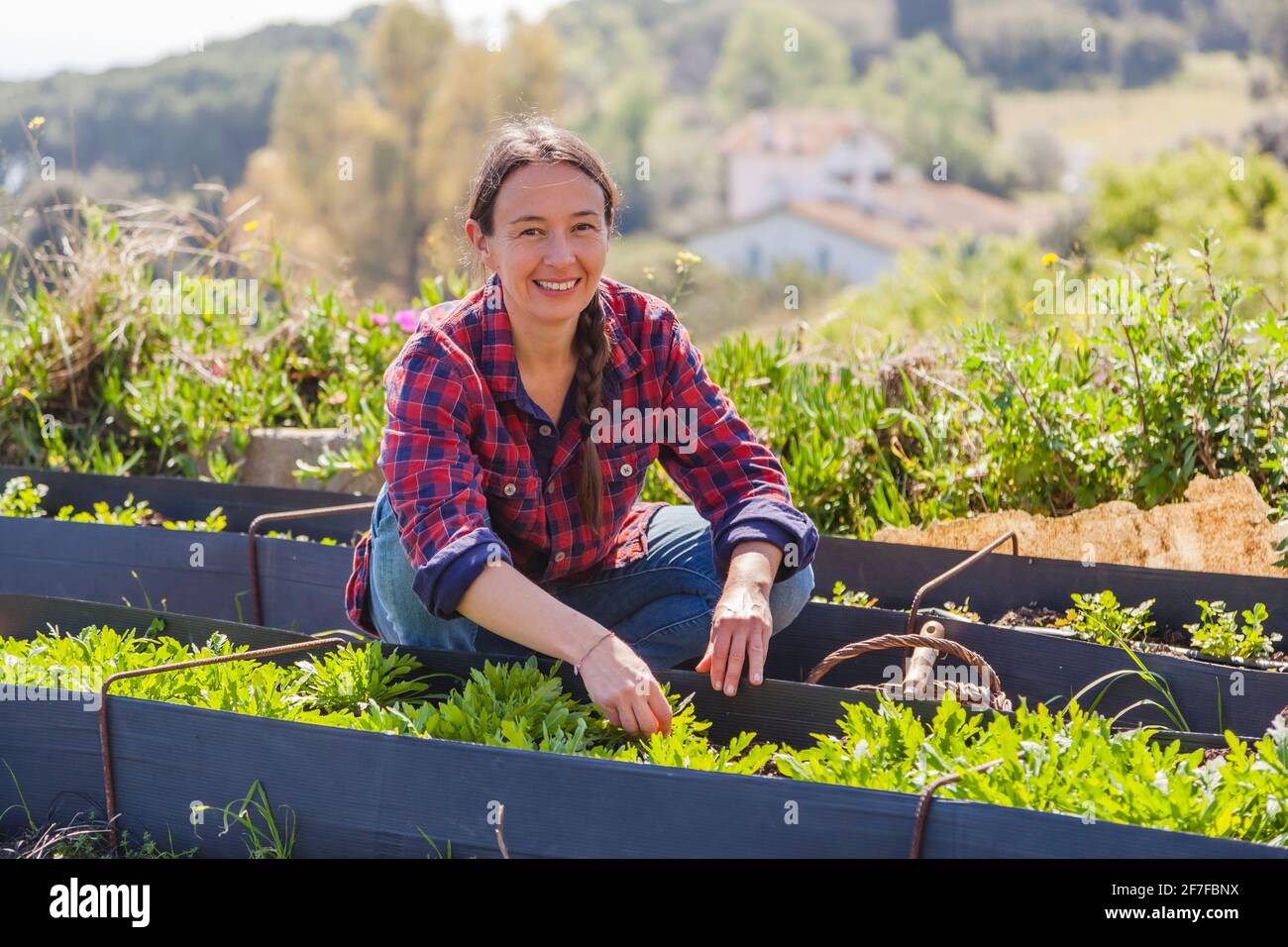 Candid portrait of a natural woman working on an organic farm in a ...
