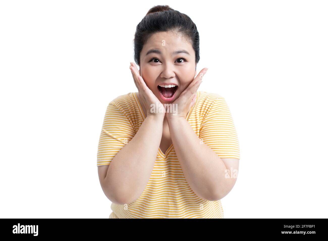 Young woman with hand on chin Stock Photo - Alamy