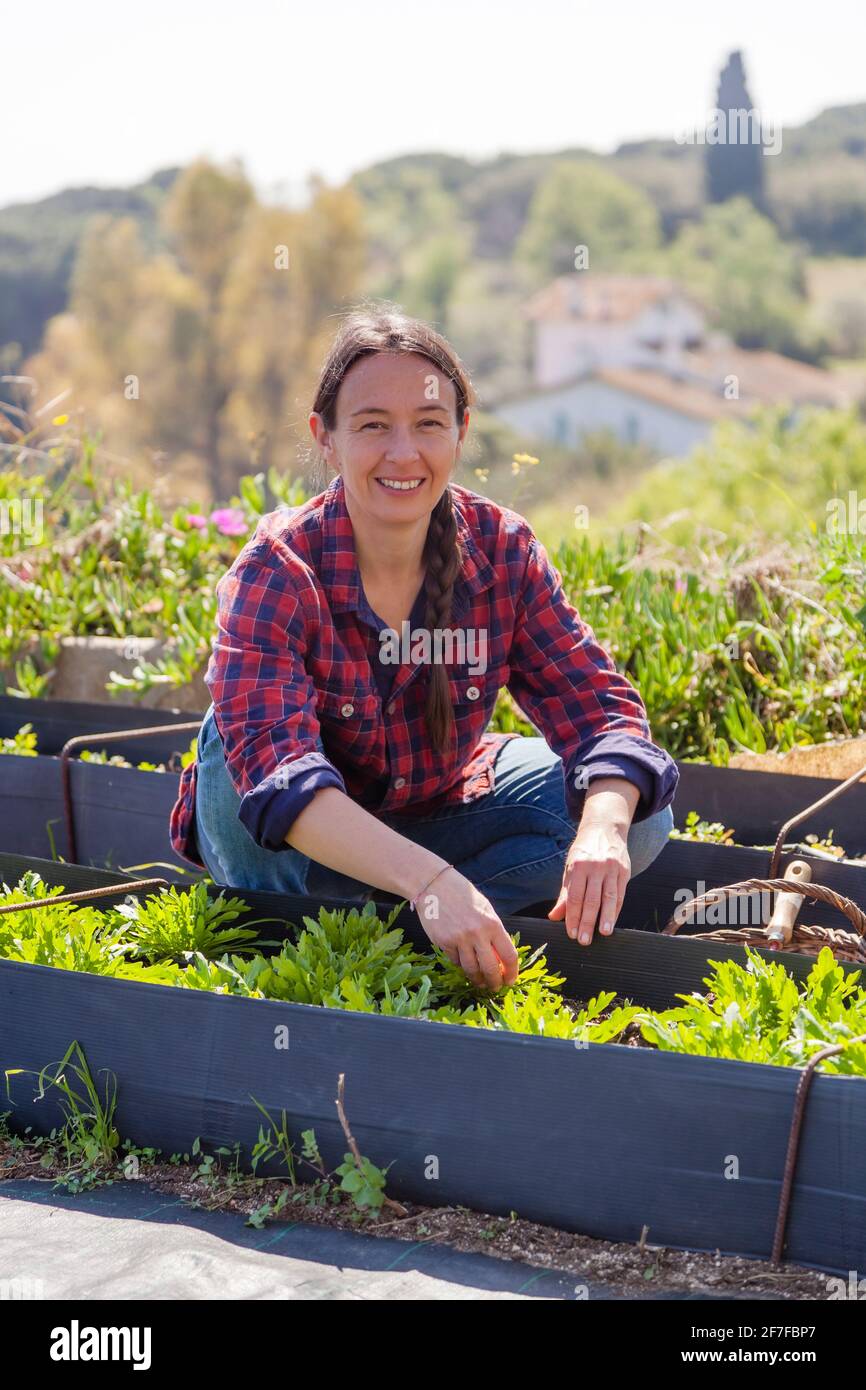 Candid portrait of a natural woman working on an organic farm in a ...