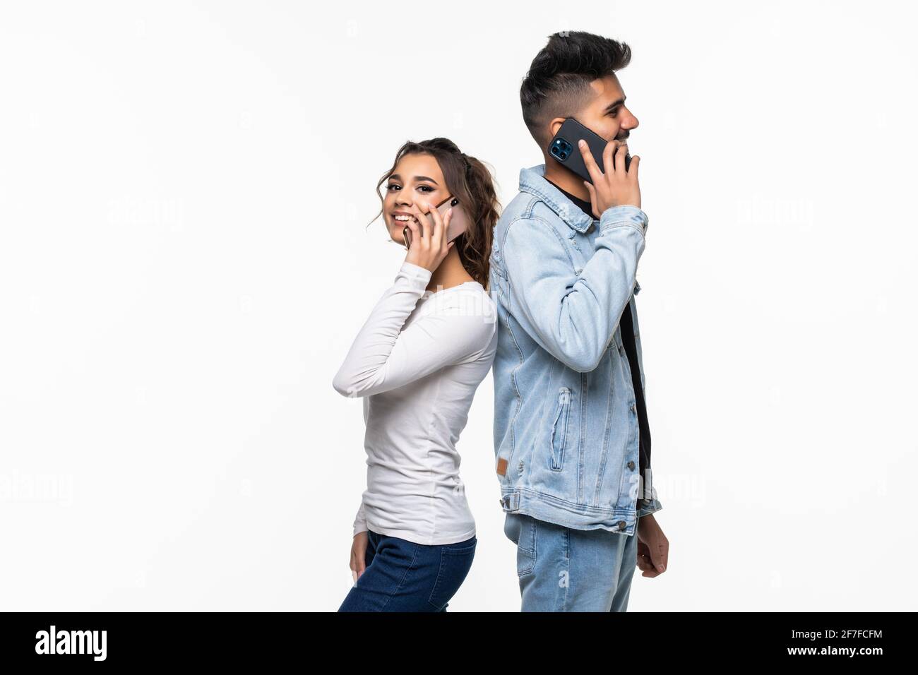 Beautiful woman and handsome man standing back to back talk on the ...