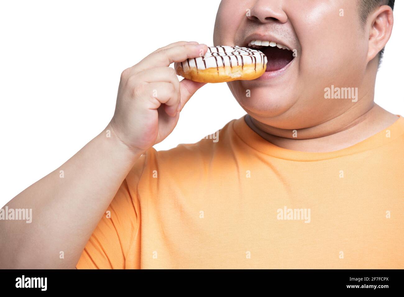 Young man eating donut Stock Photo - Alamy