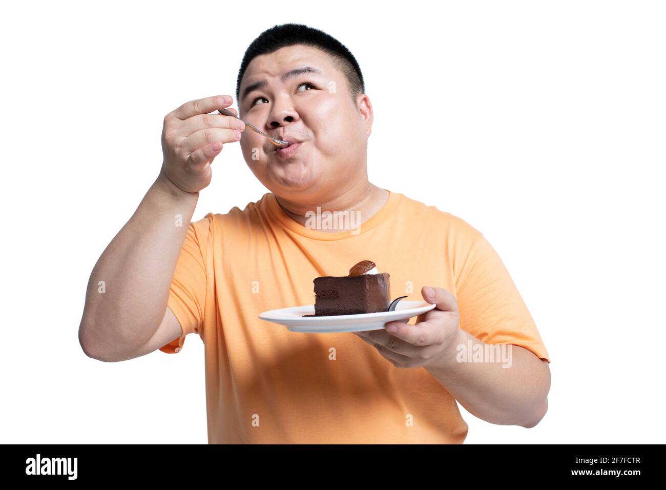 Young man eating sweet food Stock Photo - Alamy