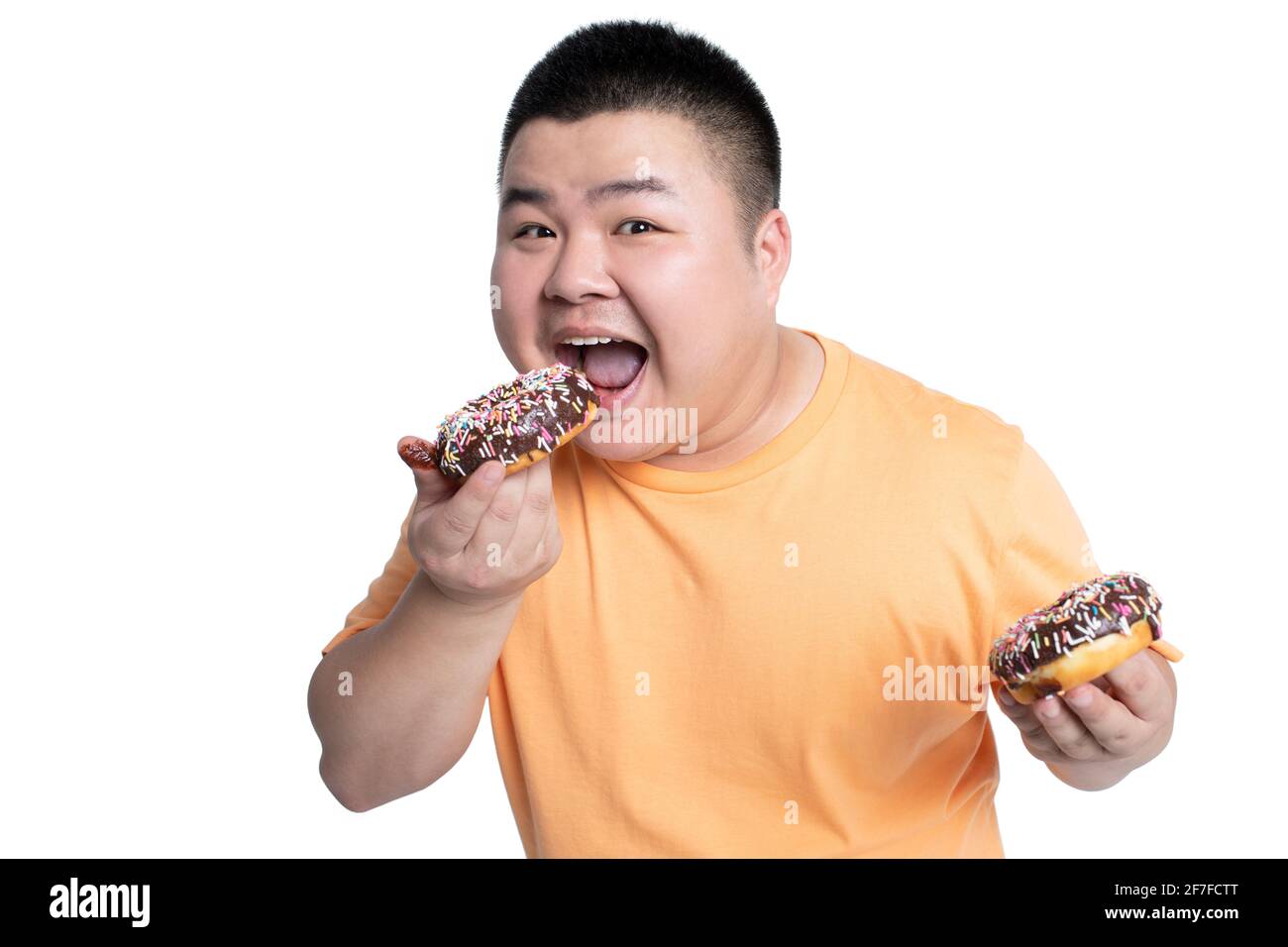 Young man eating donut hi-res stock photography and images - Alamy