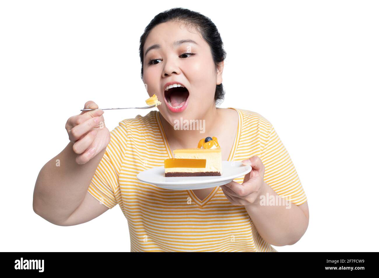 Overweight woman eating cake hi-res stock photography and images - Alamy