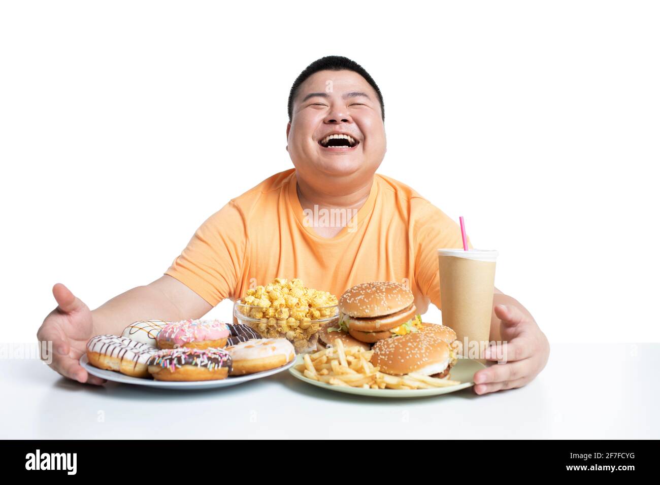 Young man eating fast food Stock Photo - Alamy