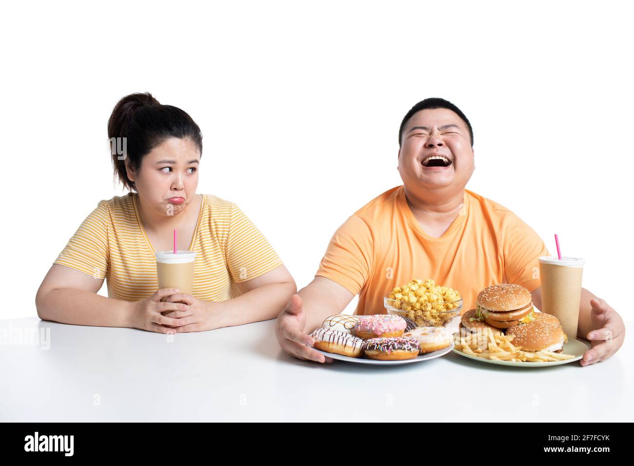 Young couple eating fast food Stock Photo - Alamy