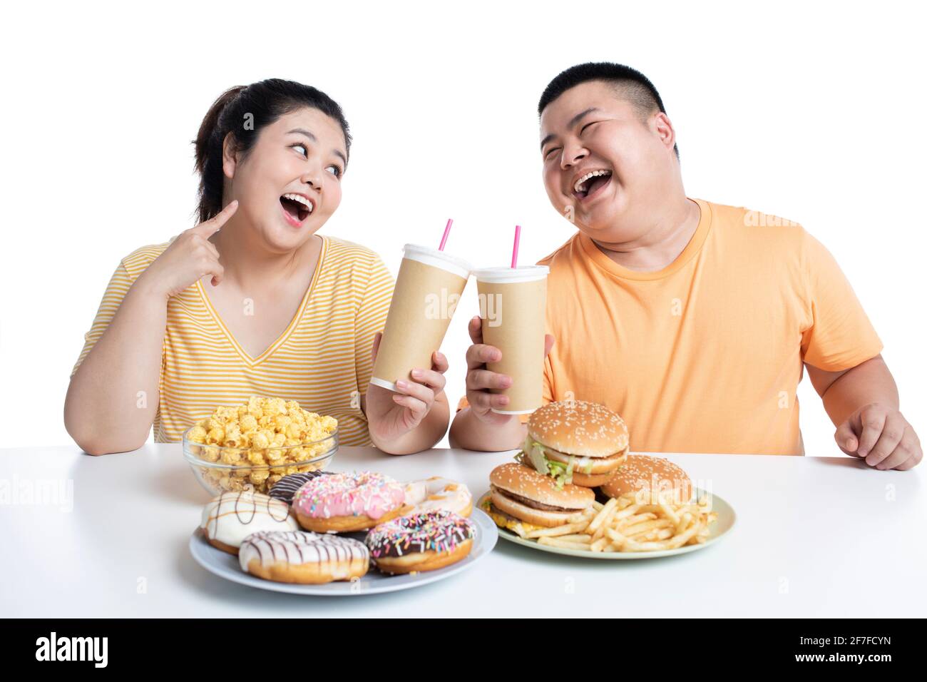 Young couple eating fast food Stock Photo - Alamy