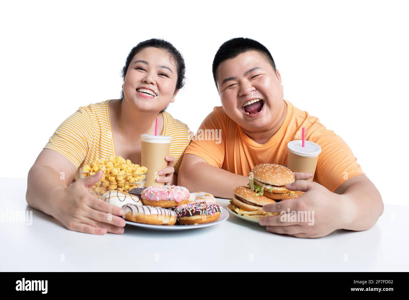 Young couple eating fast food Stock Photo - Alamy