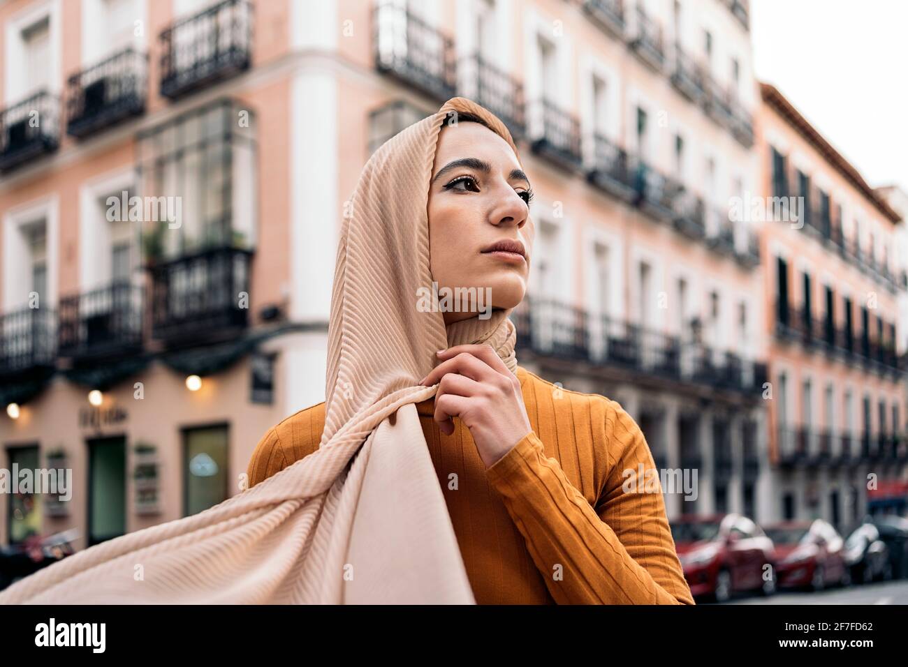 Beautiful young muslim woman standing in the street wearing hijab and ...