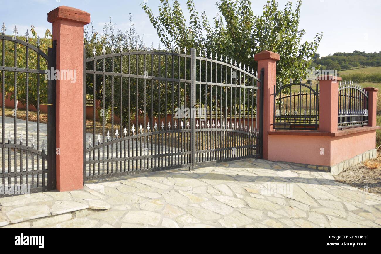 a gate on a private property made of wrought iron Stock Photo - Alamy