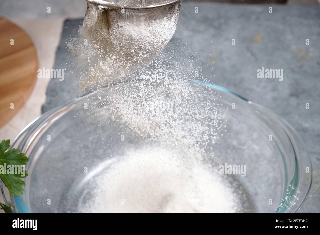 Flour is sieved with a metal sieve Stock Photo - Alamy