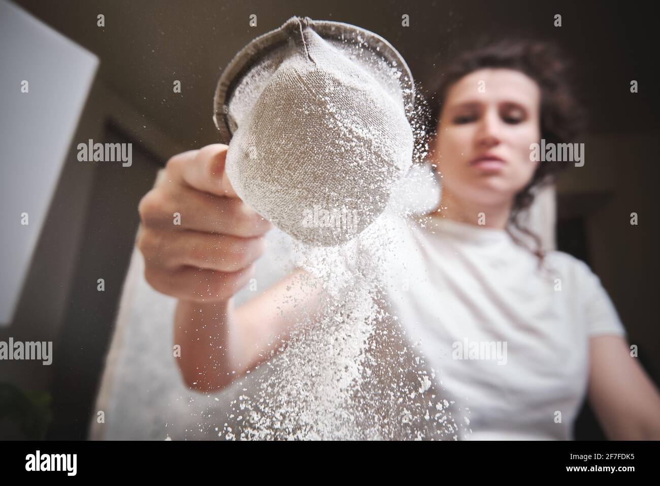 Flour is sieved with a metal sieve Stock Photo - Alamy
