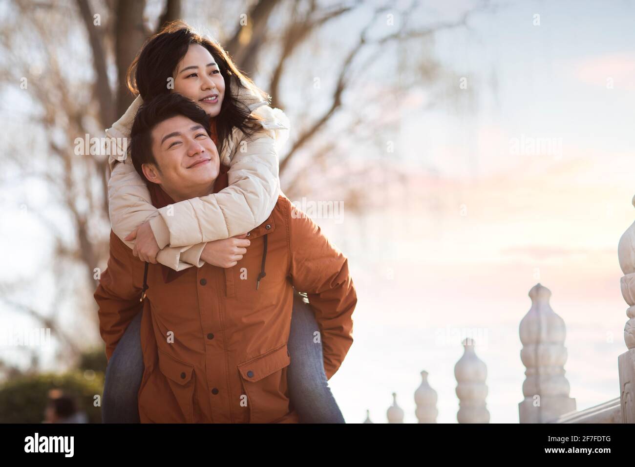 Happy young couple dating outdoors in winter Stock Photo - Alamy