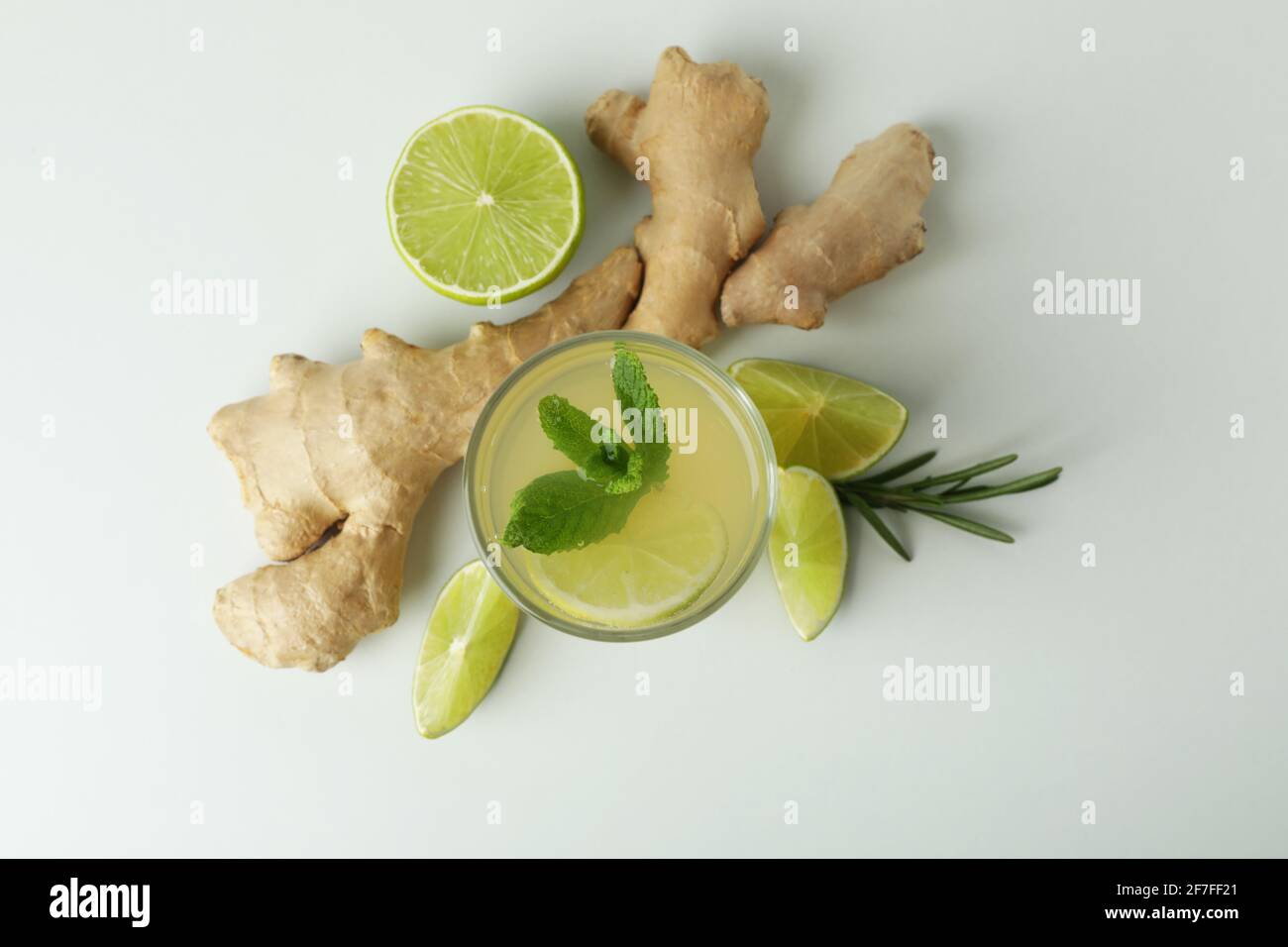 Glass of ginger beer and ingredients on white background Stock Photo ...