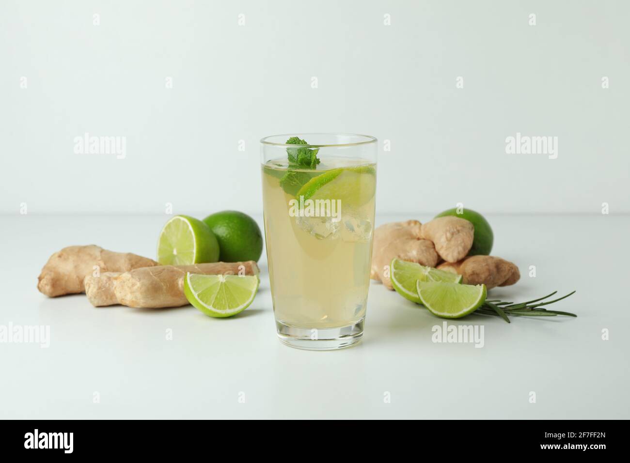 Glass of ginger beer and ingredients on white background Stock Photo ...
