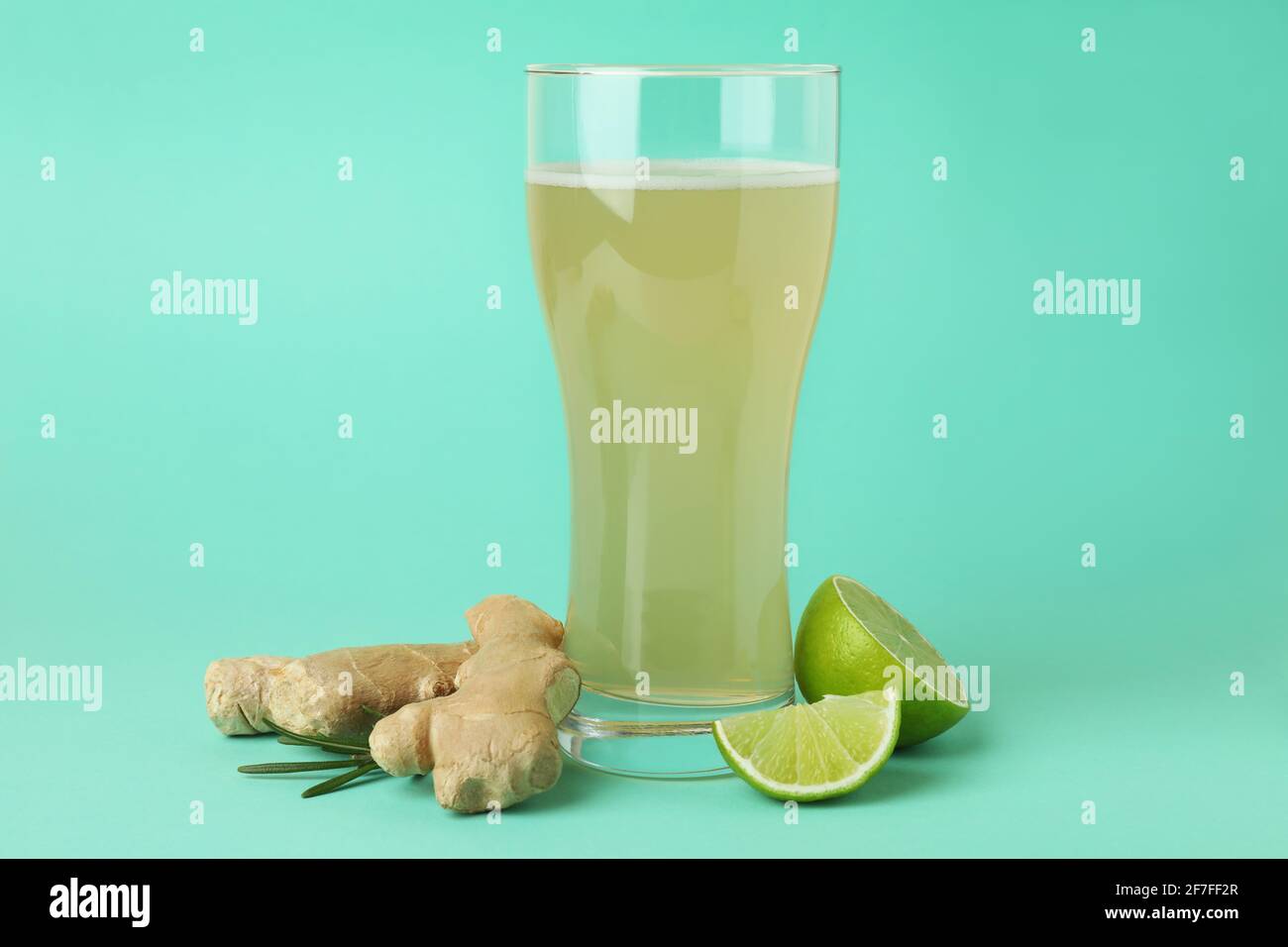 Glass of ginger beer and ingredients on mint background Stock Photo - Alamy
