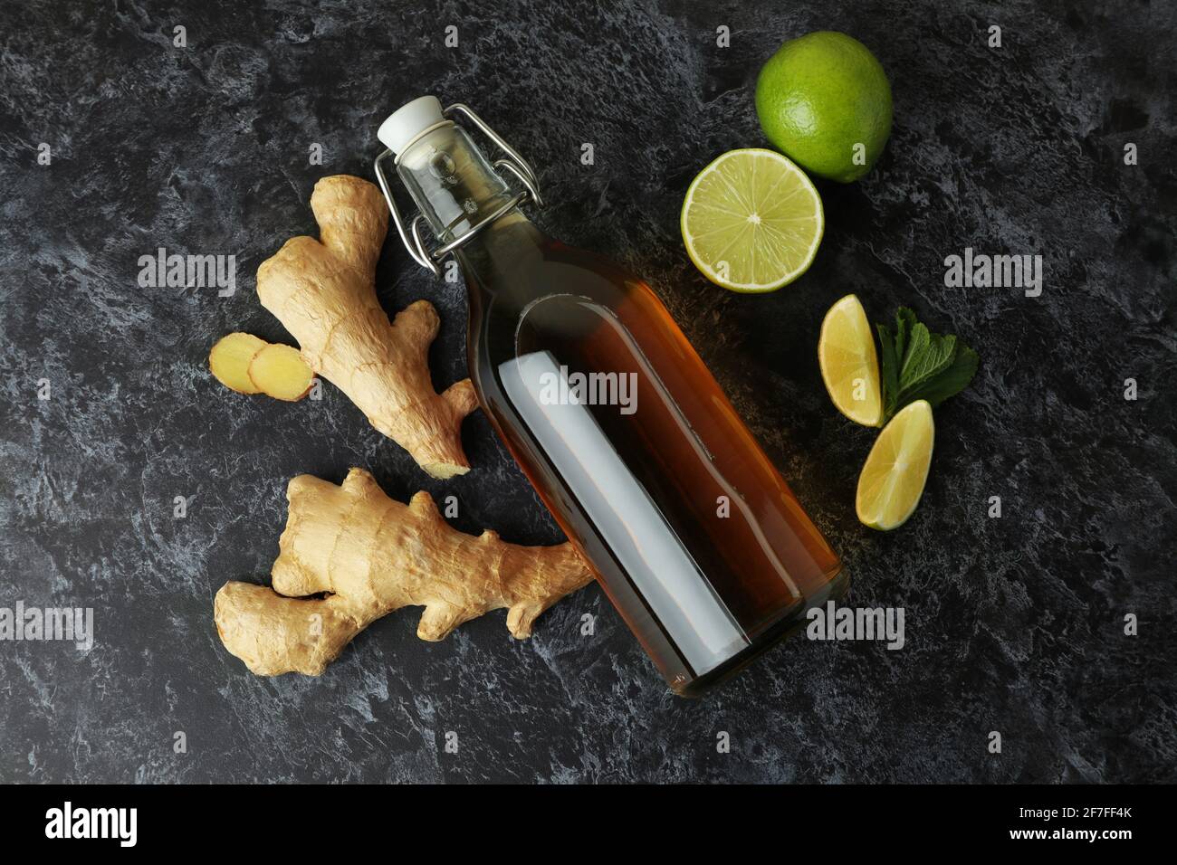 Bottle of ginger beer and ingredients on black smoky background Stock ...
