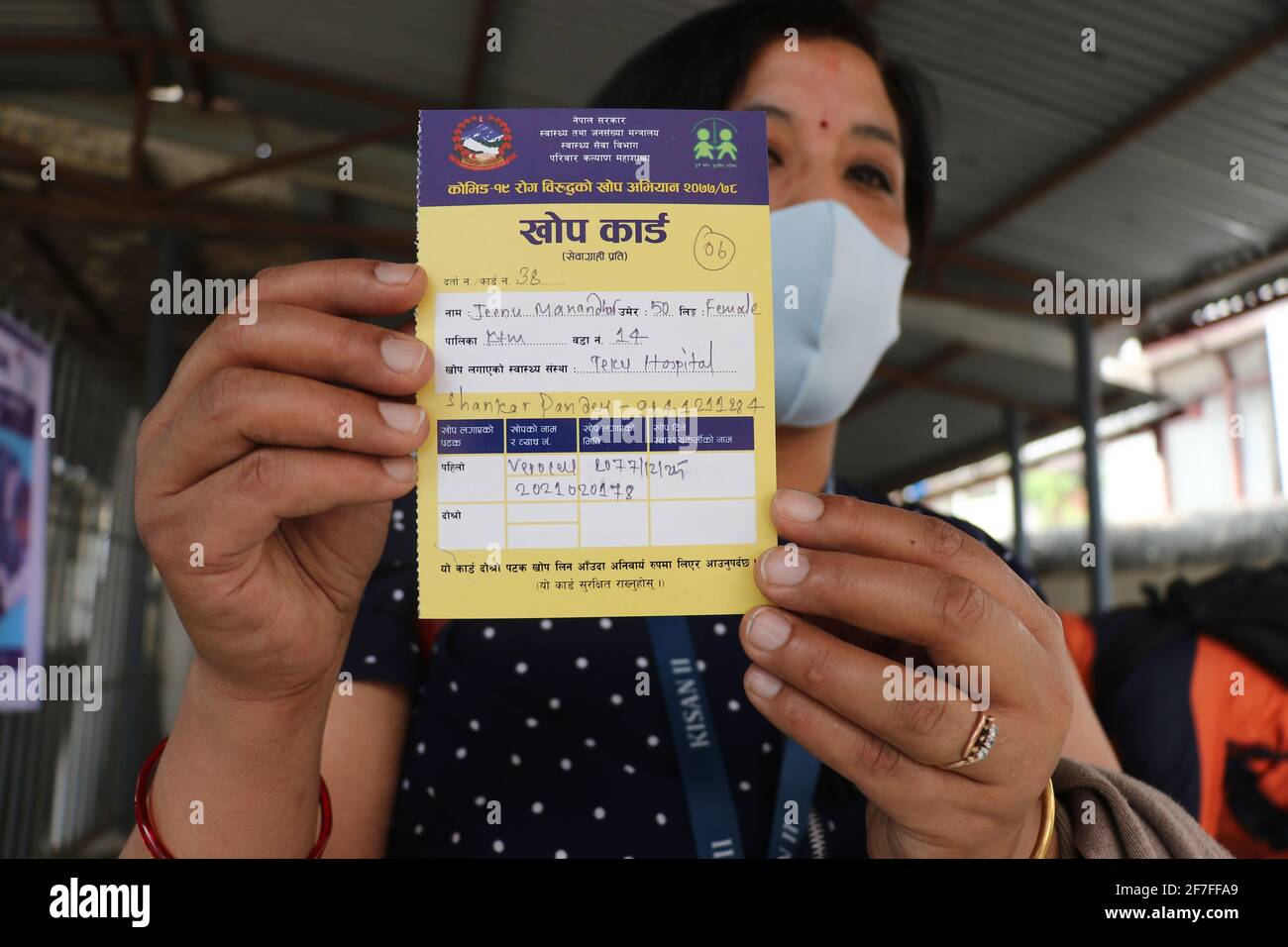Kathmandu, NE, Nepal. 7th Apr, 2021. A woman shows her vaccination card ...