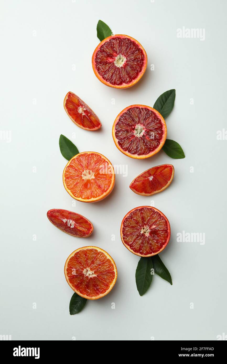 Red orange slices with leaves on white background, top view Stock Photo ...