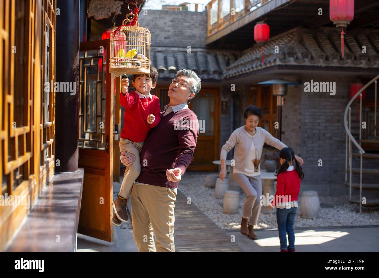 Happy family having fun in yard Stock Photo - Alamy